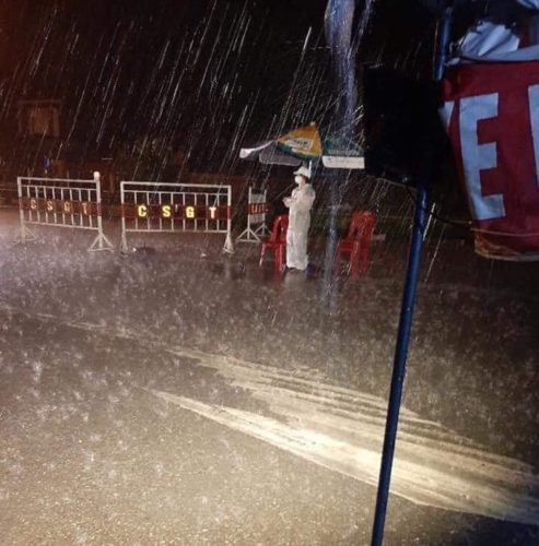 Frontline Workers Stand In Heavy Rain & Fall Asleep On Chairs